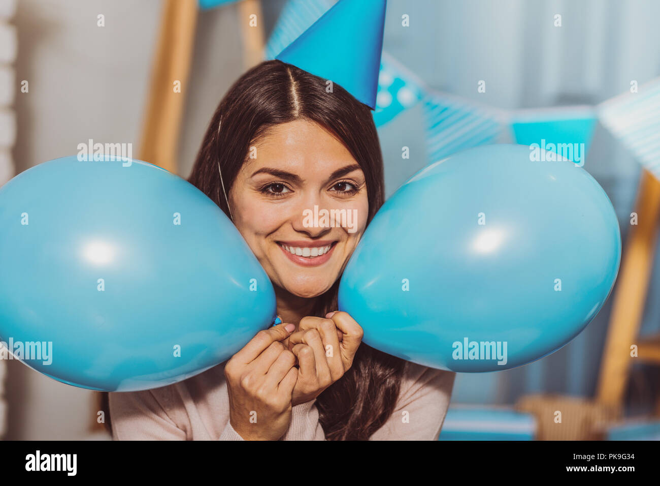 Cheerful merry woman waiting for birthday celebration Stock Photo - Alamy