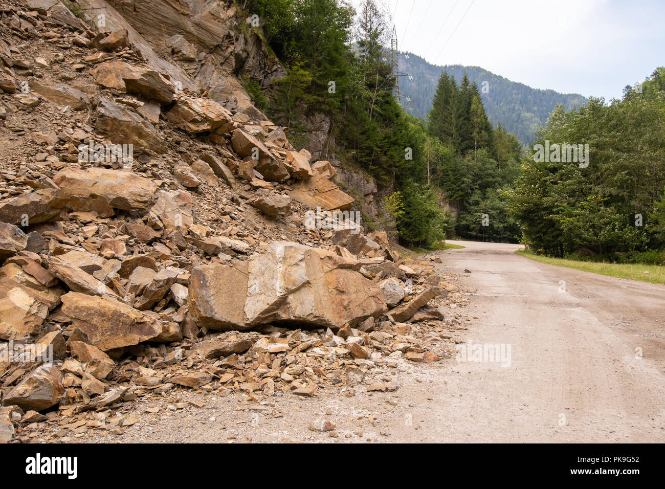 Asphalt road broken by a mountain avalanche Stock Photo - Alamy