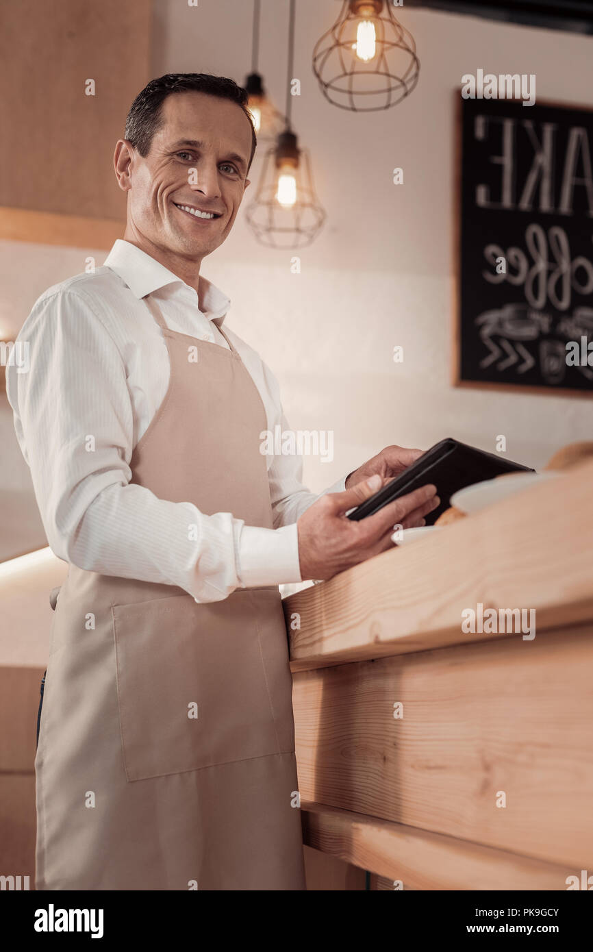 Positive joyful businessman running a cafe Stock Photo - Alamy