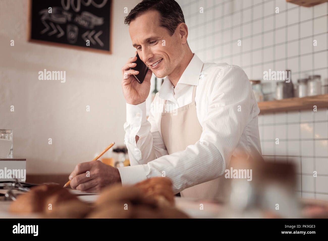 Positive smart man taking notes Stock Photo - Alamy