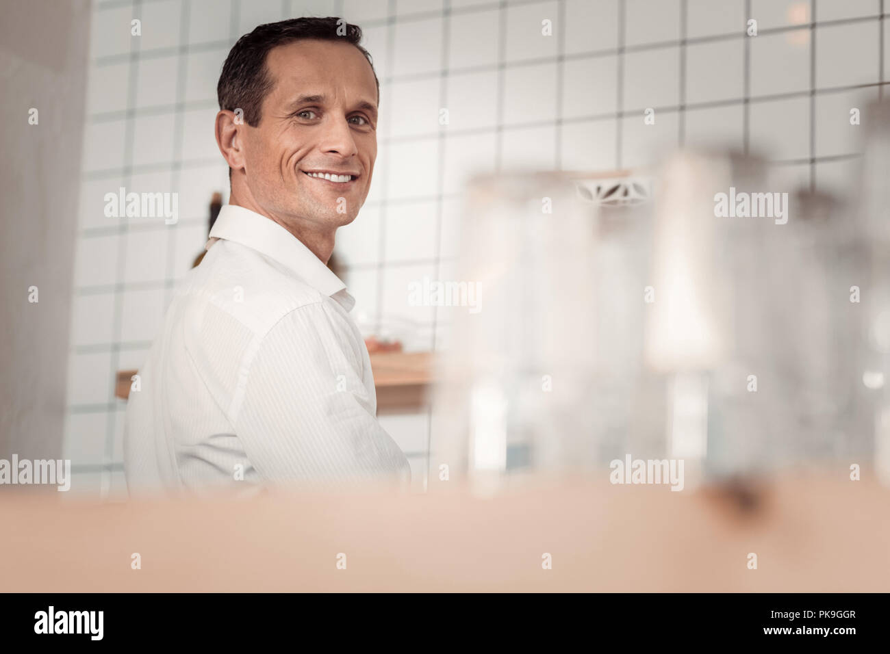 Cheerful positive man being at work Stock Photo - Alamy Cheerful positive man being at work Stock Photo - Alamy