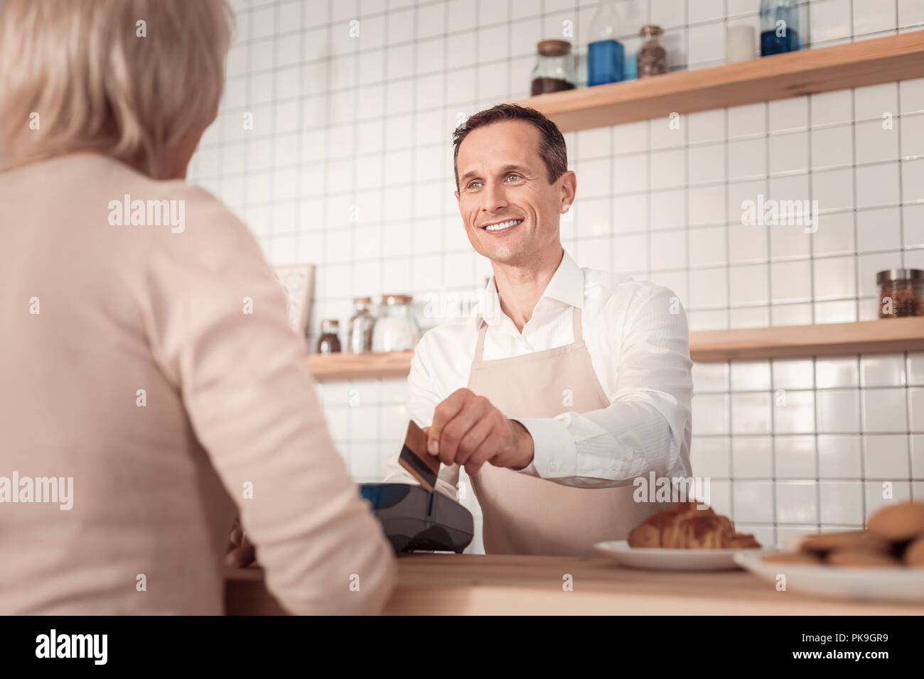 Senior woman cashier counter hi-res stock photography and images - Alamy