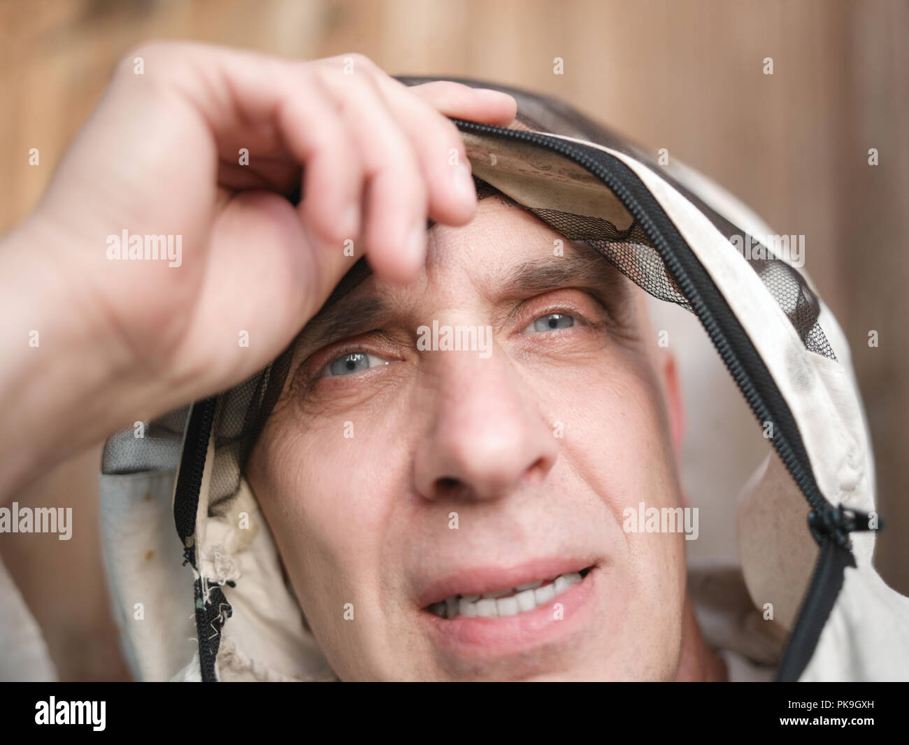 A beekeeper face looks tired, outdoor portrait Stock Photo - Alamy