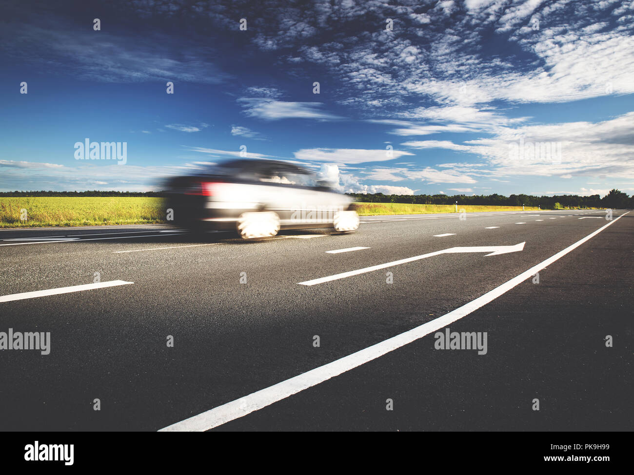 Car on asphalt road in beautiful spring day Stock Photo - Alamy