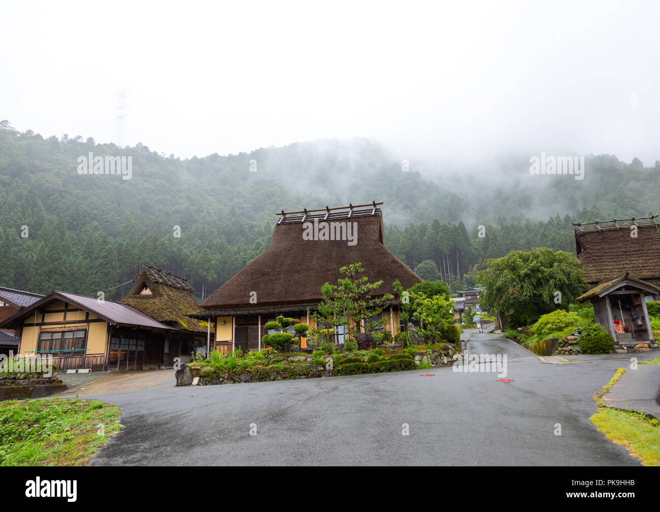Thatched roofed houses in a traditional village in the fog, Kyoto ...