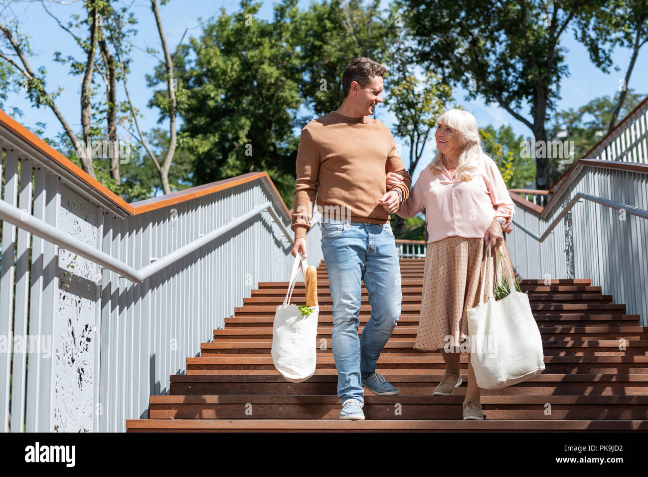 Positive delighted people talking about good weather Stock Photo - Alamy
