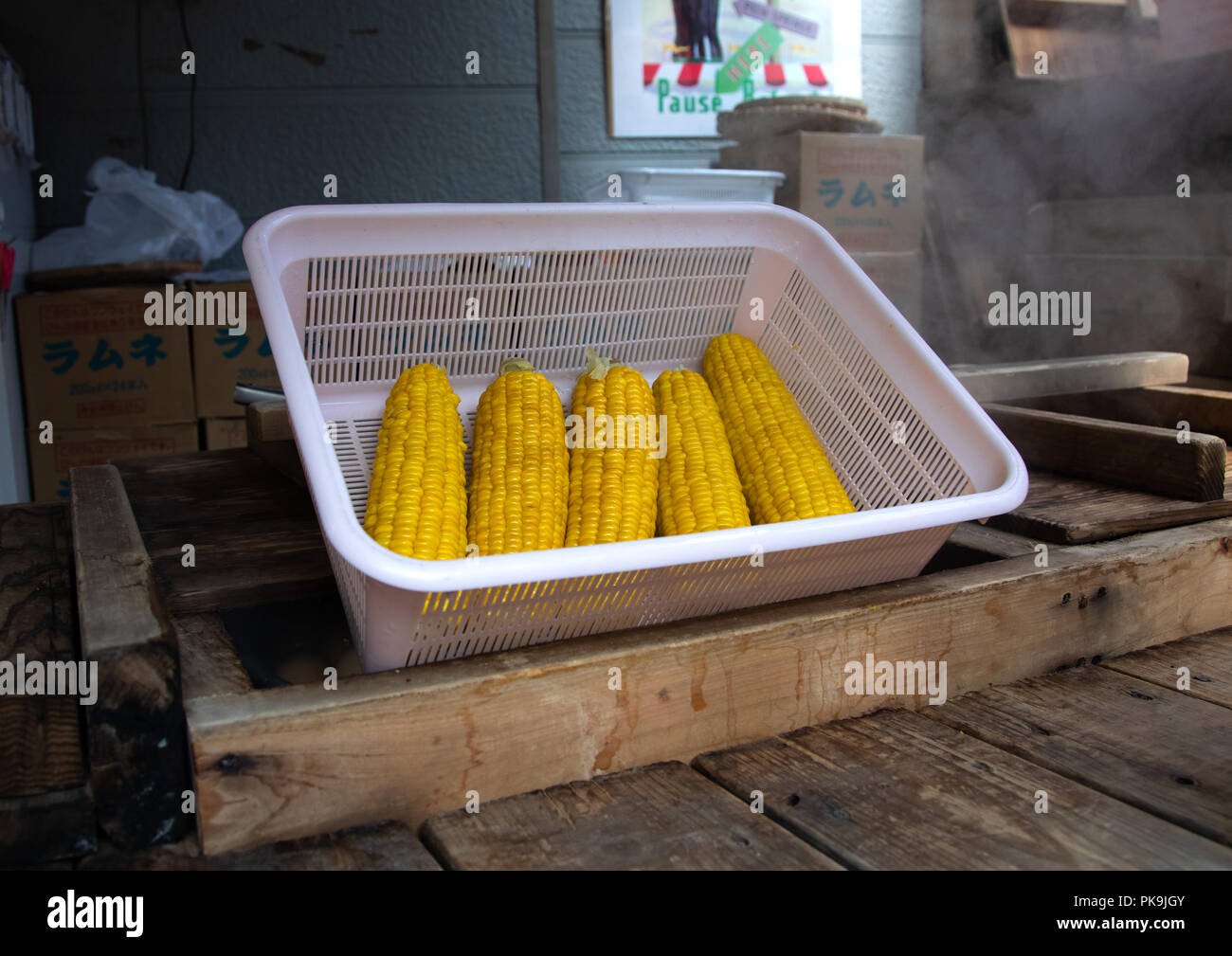 Corns for sale to cook in the hot steam of Kamado jigoku cooking pot ...