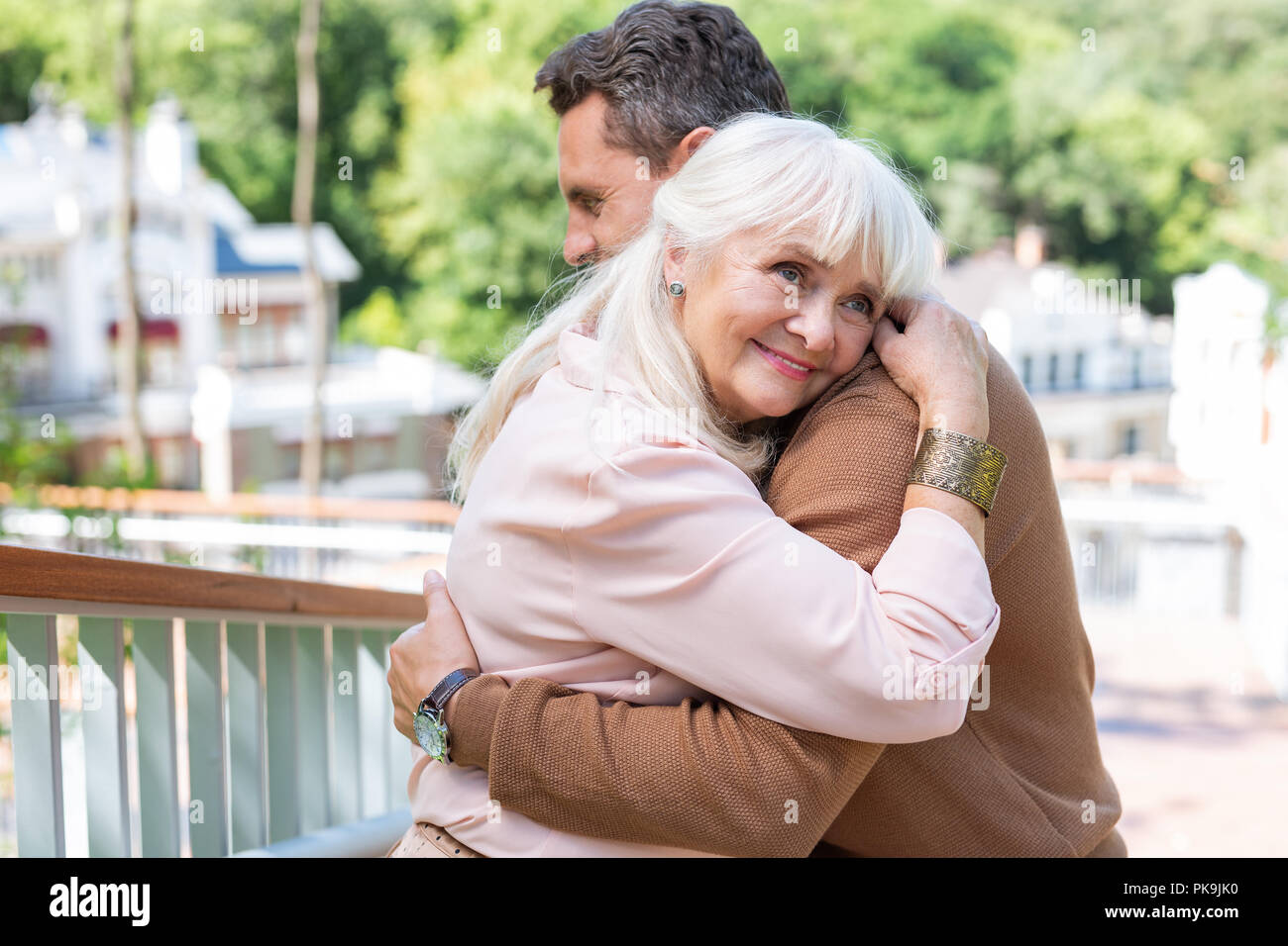 Kind female person leaning on shoulder of her son Stock Photo - Alamy