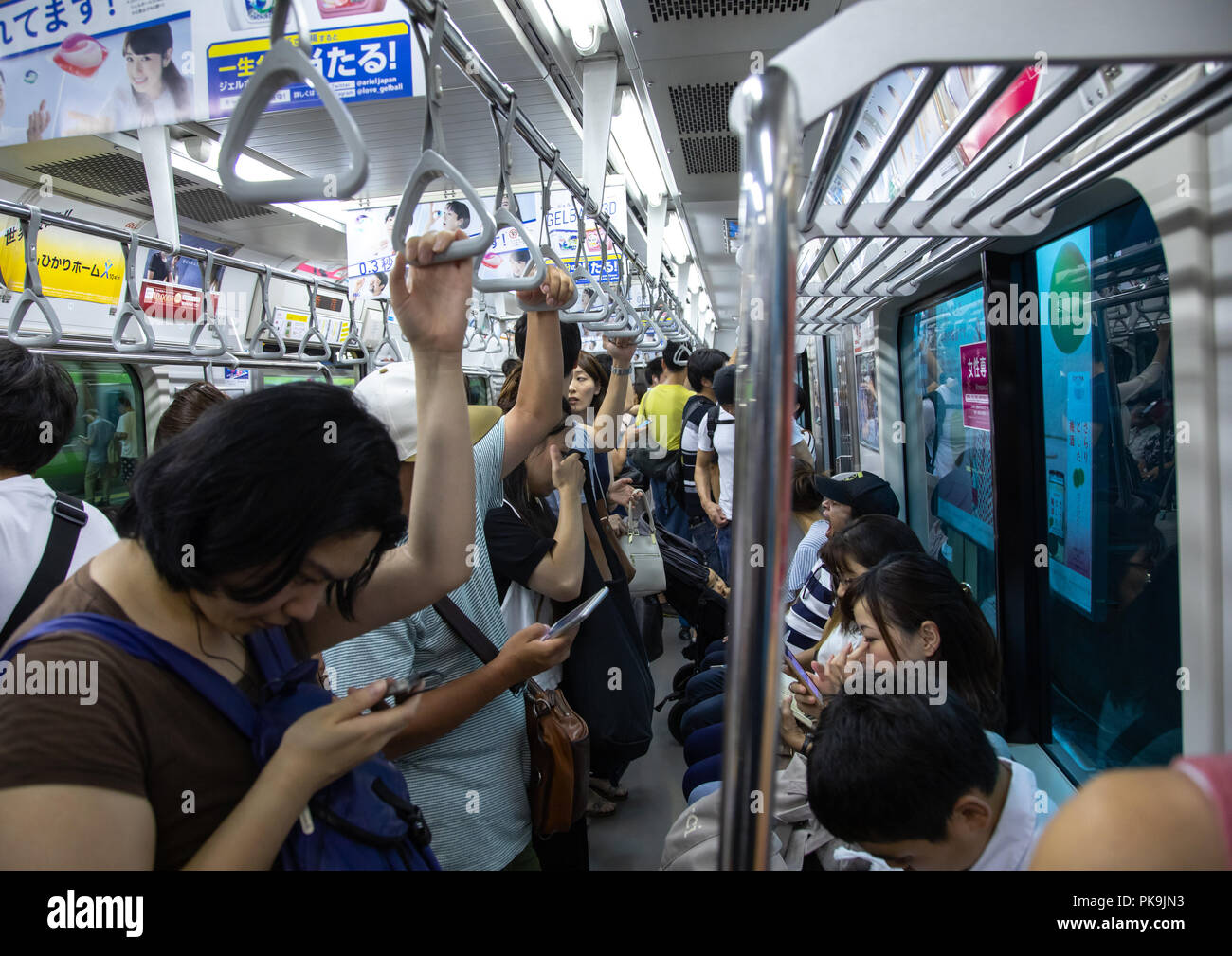 Japanese passengers in the subway using their mobile phones, Kanto ...