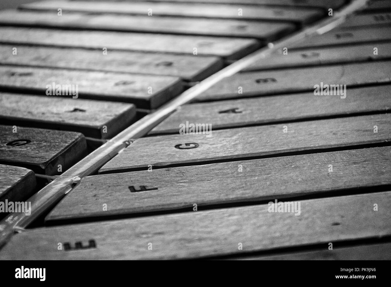 Wooden musical instrument with notes engraved Stock Photo - Alamy
