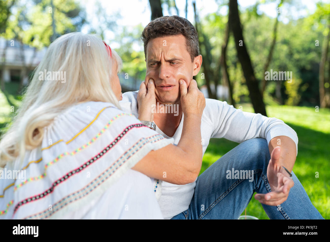 Negative delighted serious male staring at his parent Stock Photo - Alamy