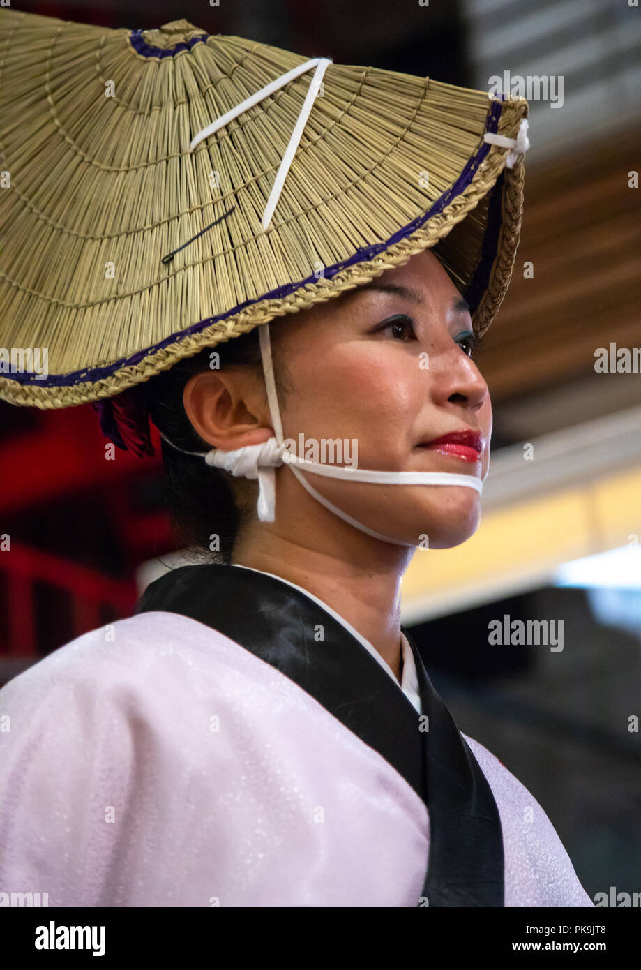 Japanese woman with straw hat during the Koenji Awaodori dance summer ...
