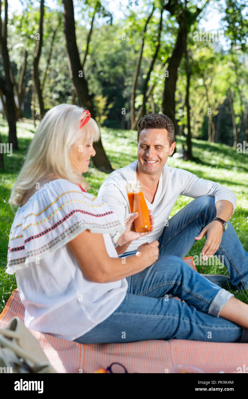 Positive delighted people touching with glass bottles Stock Photo - Alamy