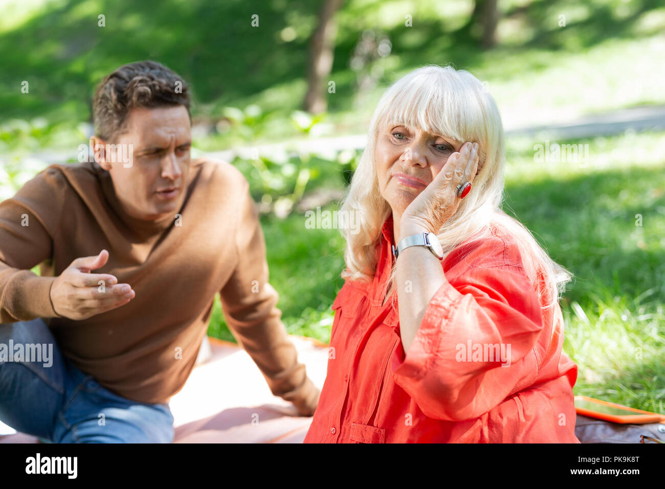 Upset blonde woman being seep in thoughts Stock Photo - Alamy