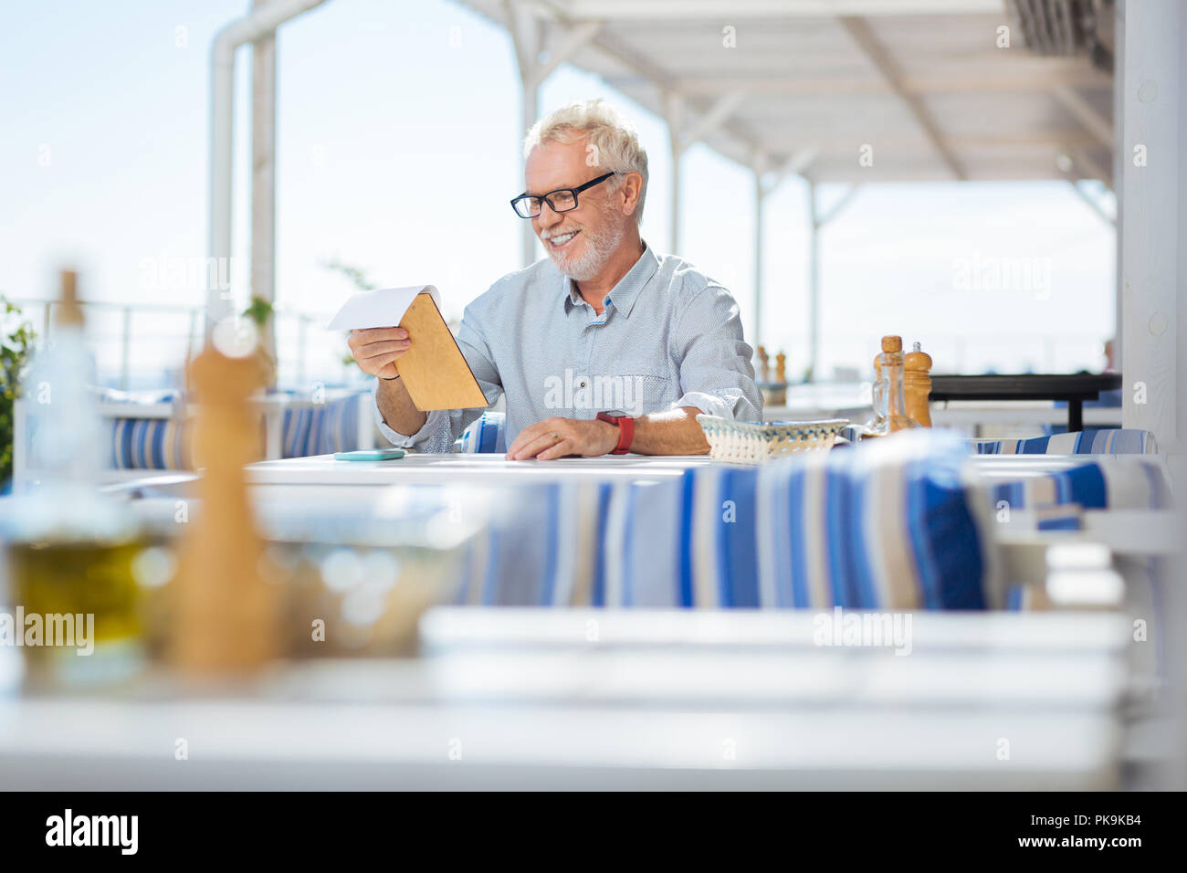 Senior man reading menu hi-res stock photography and images - Alamy