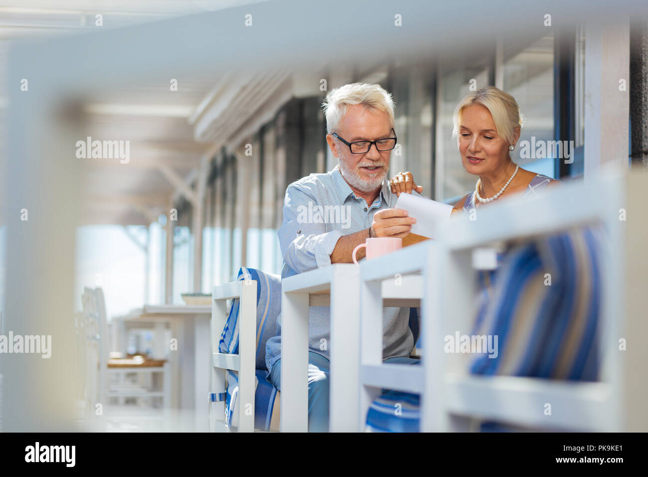 Smart nice aged couple going out together Stock Photo - Alamy