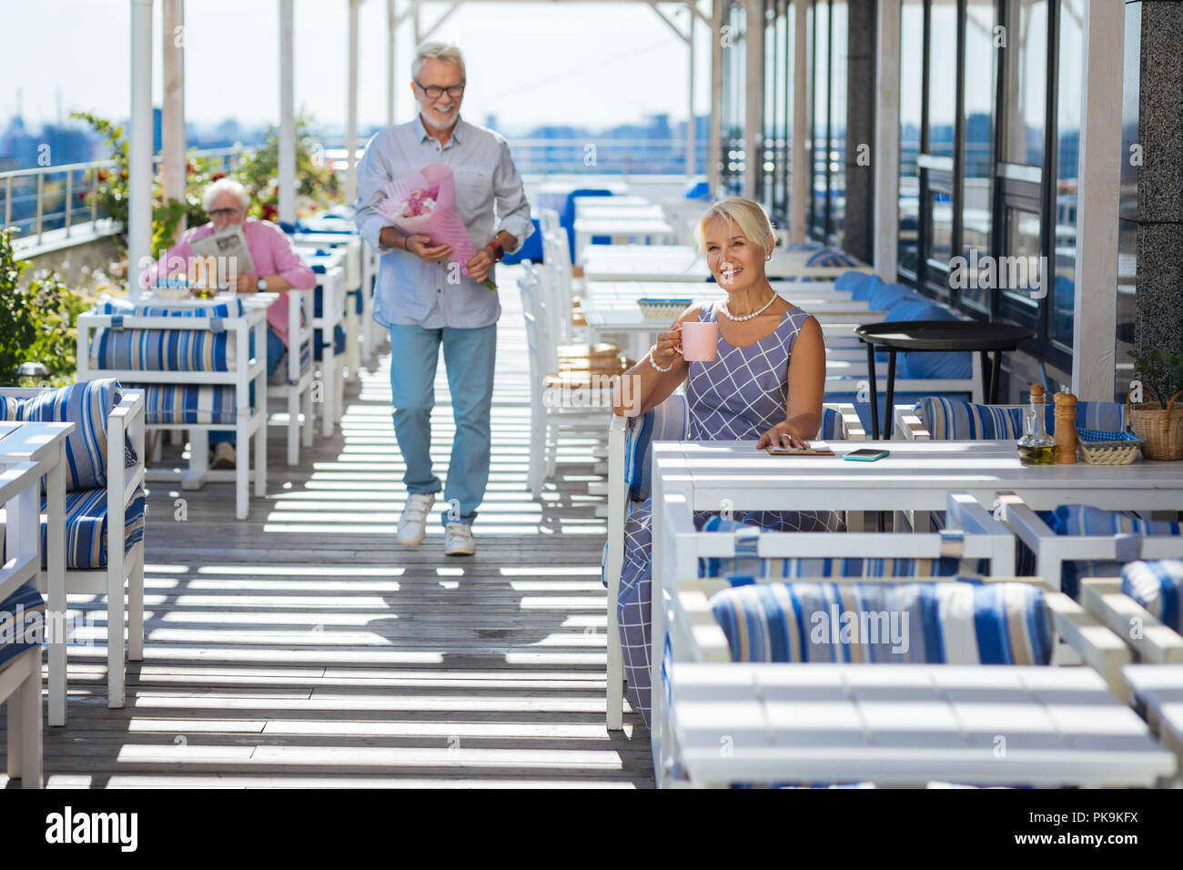 Cheerful happy woman sitting in the restaurant Stock Photo - Alamy