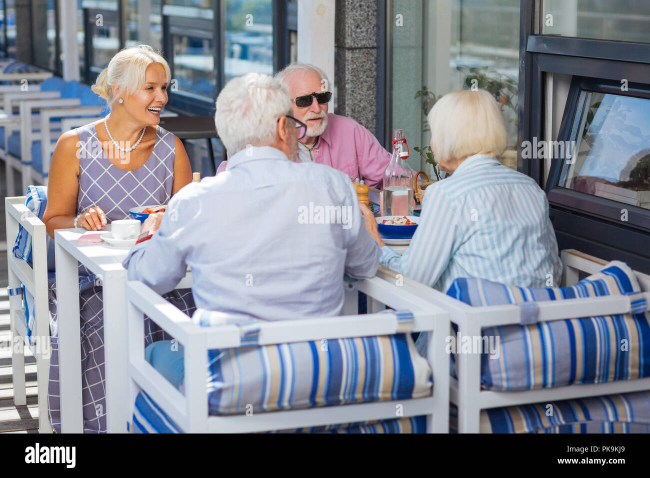Joyful elderly people talking to each other Stock Photo - Alamy
