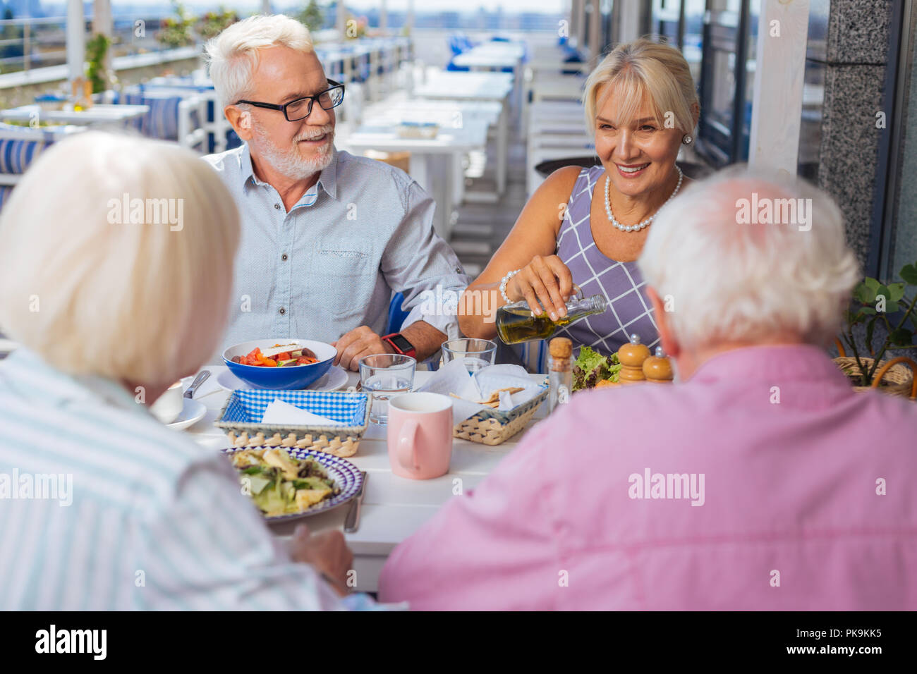 Delighted elderly people enjoying their meal together Stock Photo - Alamy
