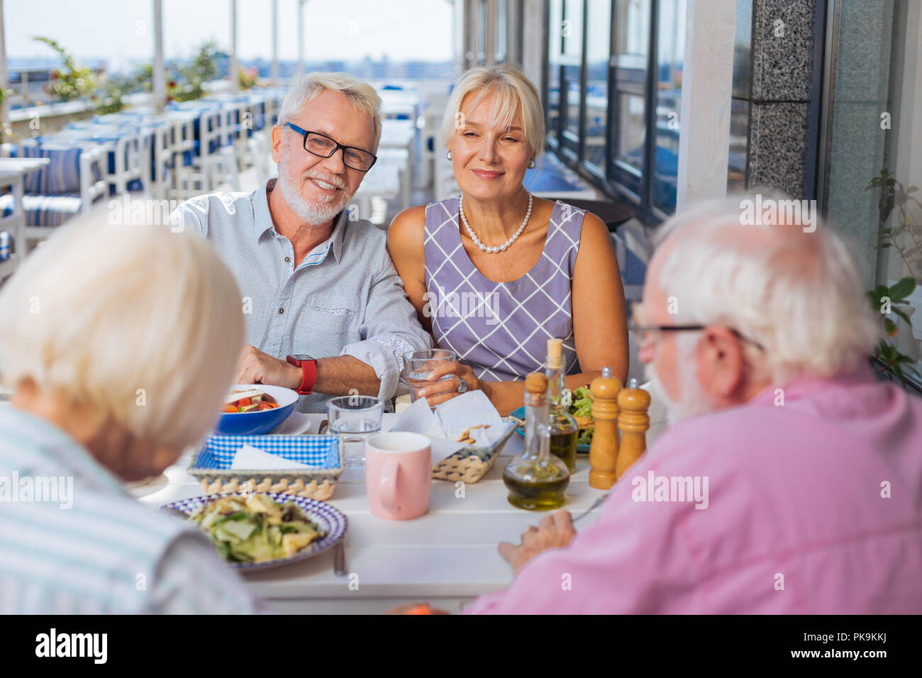 Nice aged friends meeting together for lunch Stock Photo - Alamy