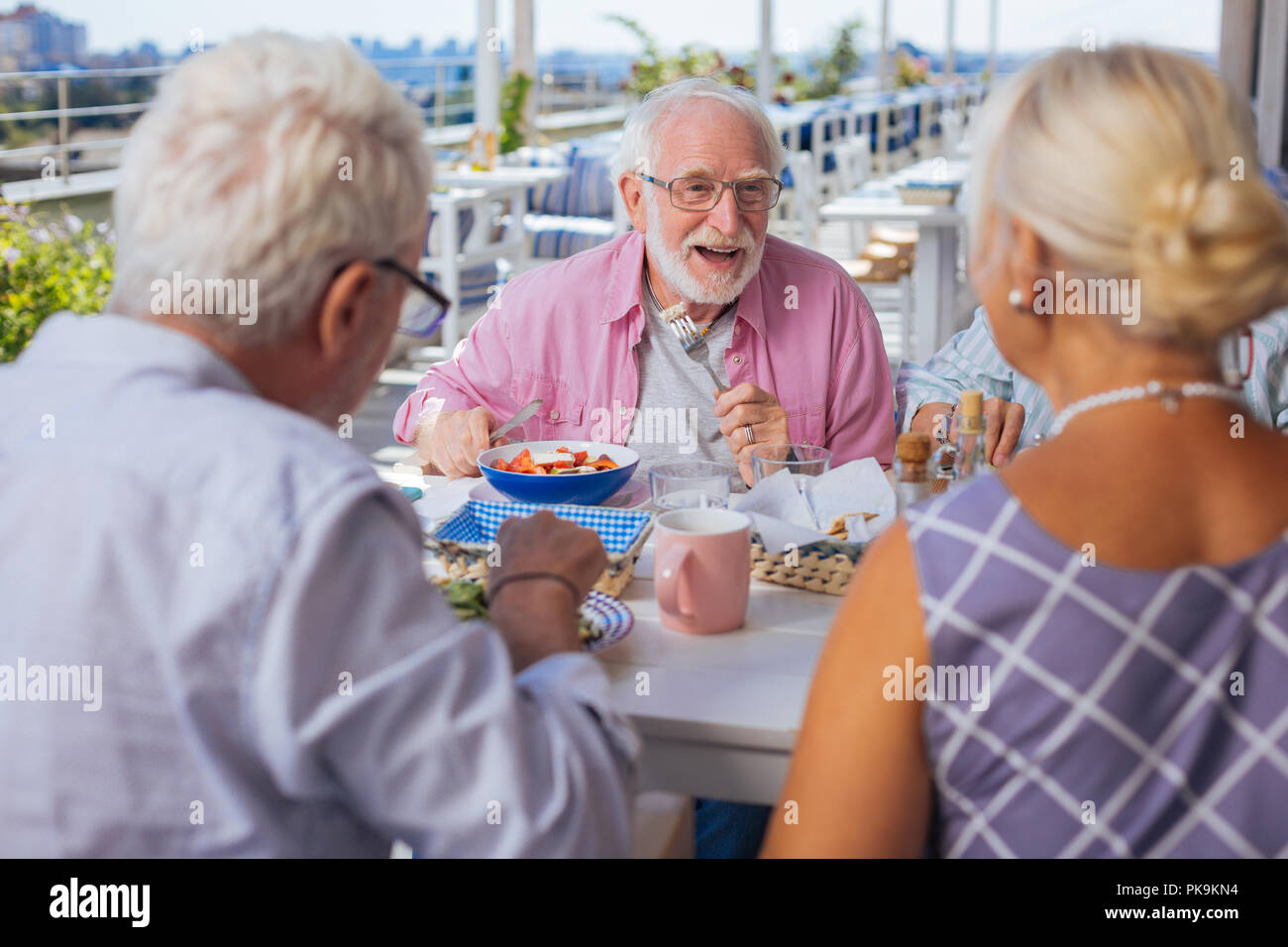 Nice aged man telling an interesting story Stock Photo - Alamy
