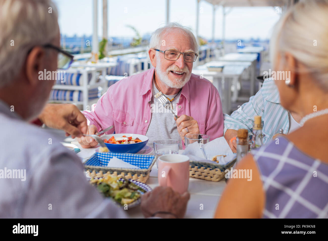 Positive joyful nice man eating his meal Stock Photo - Alamy
