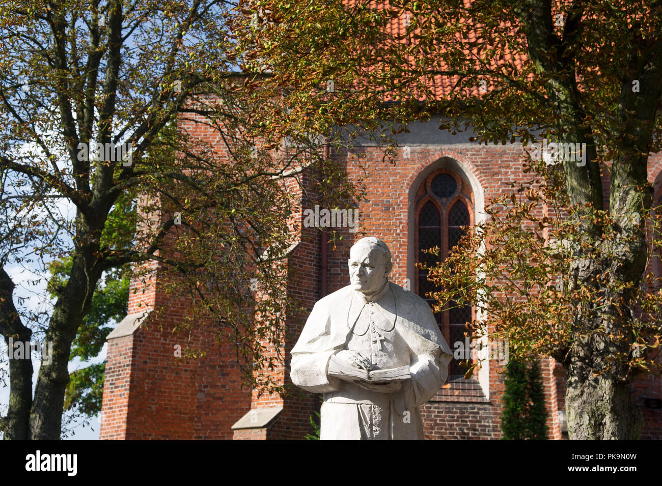 Statue of Pope Saint John Paul II in front of Gothic Church of St ...