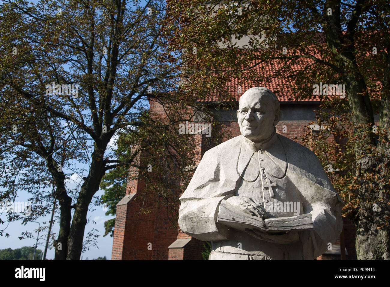 Statue of Pope Saint John Paul II in front of Gothic Church of St ...