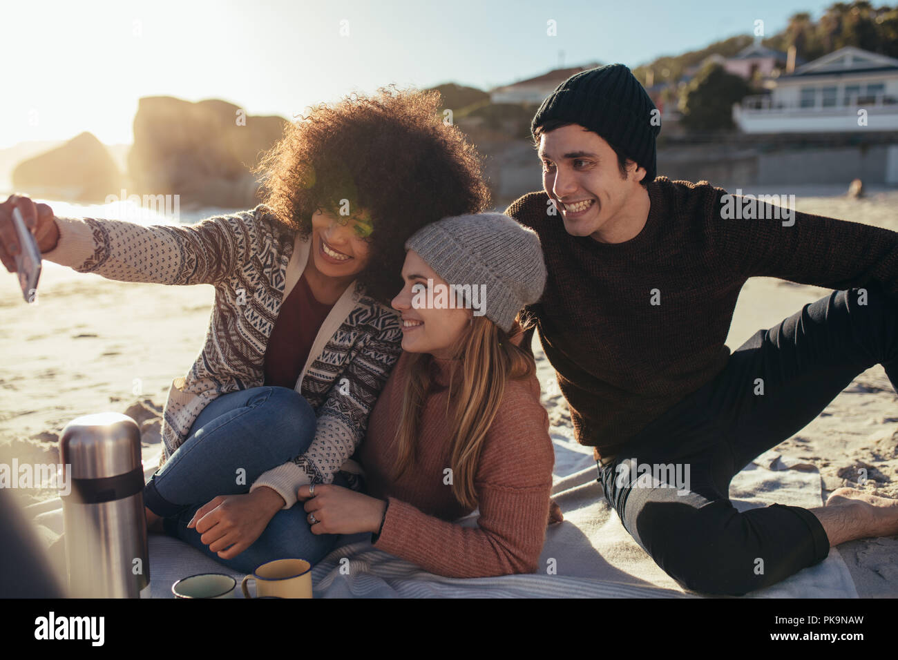 Group of happy friends having fun together and taking selfie using ...