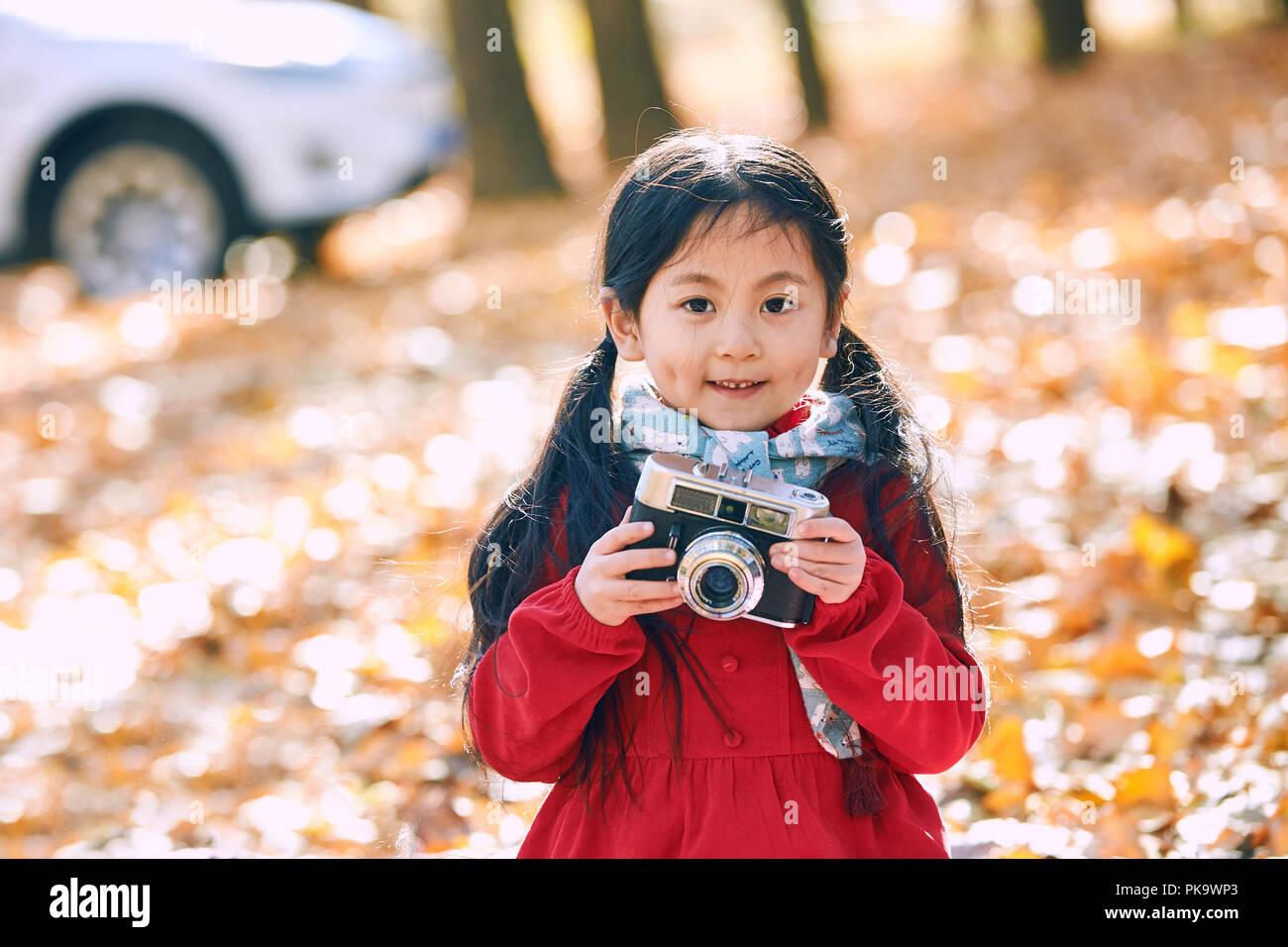 Lovely little girl with a camera Stock Photo - Alamy