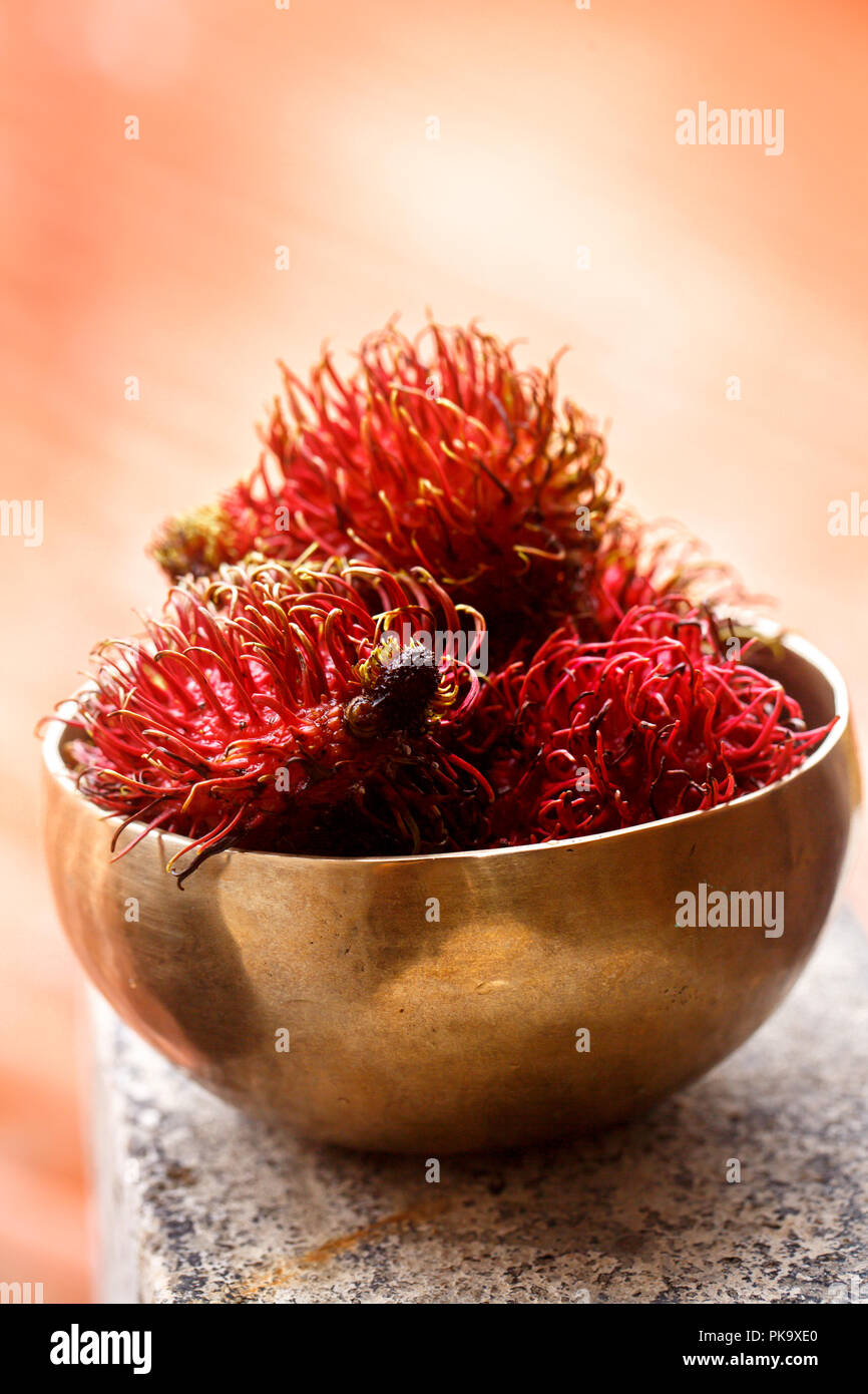 Exotic hairy fruit rambutan in rustic style Stock Photo - Alamy