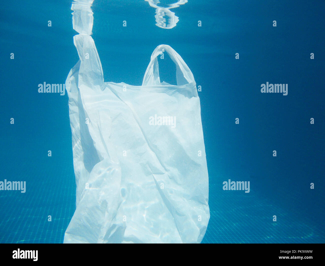 Plastic bag floating into the water. Polluted enviromental. Recycle ...