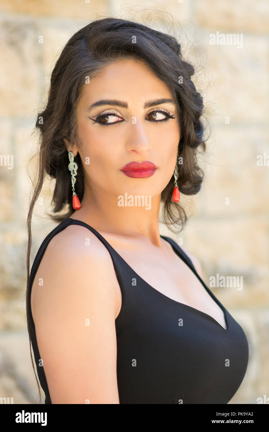 Serious woman looking over shoulder outdors Stock Photo - Alamy