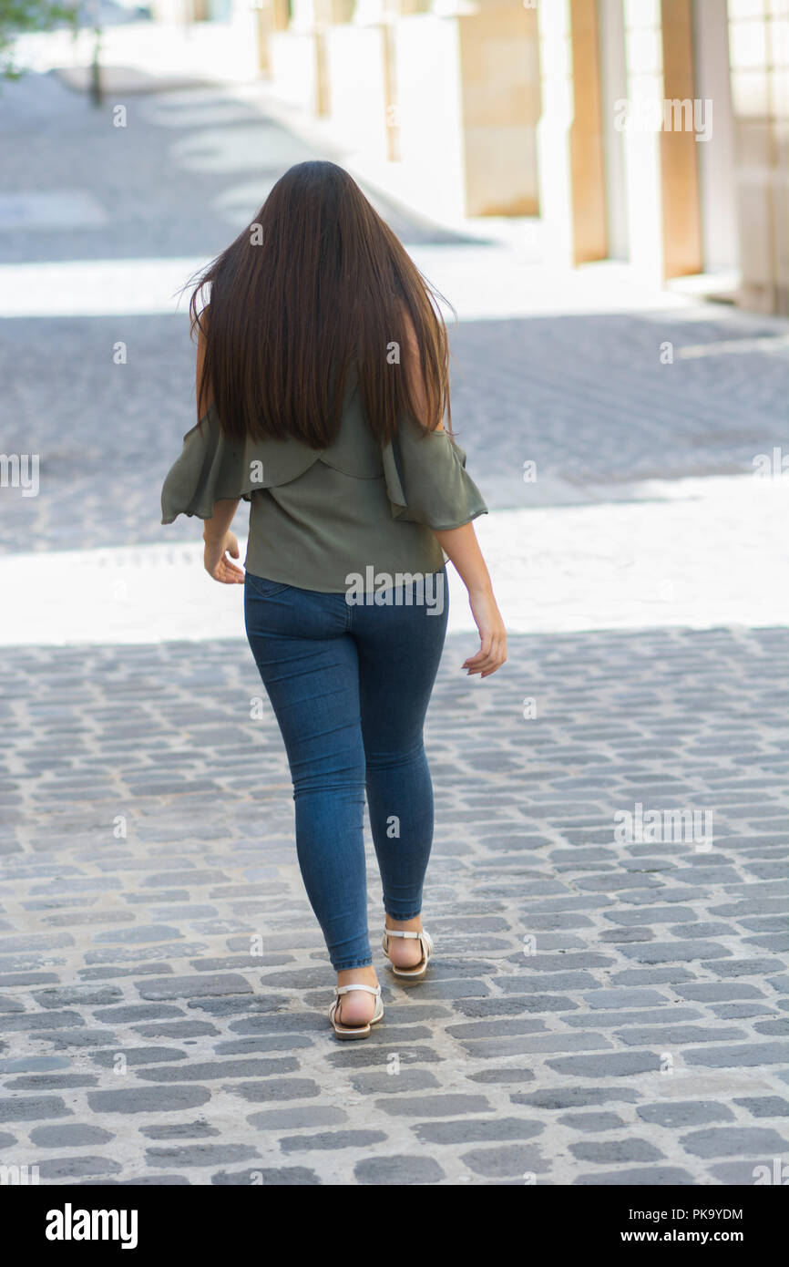 Teen girl walking alone rear view hi-res stock photography and images ...