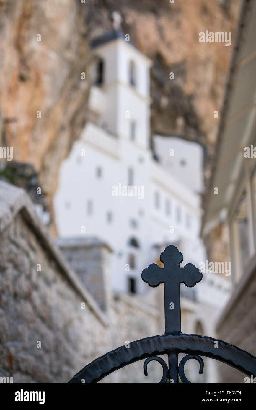Cross on a metal gates to the stunningly located famous landmark Ostrog ...