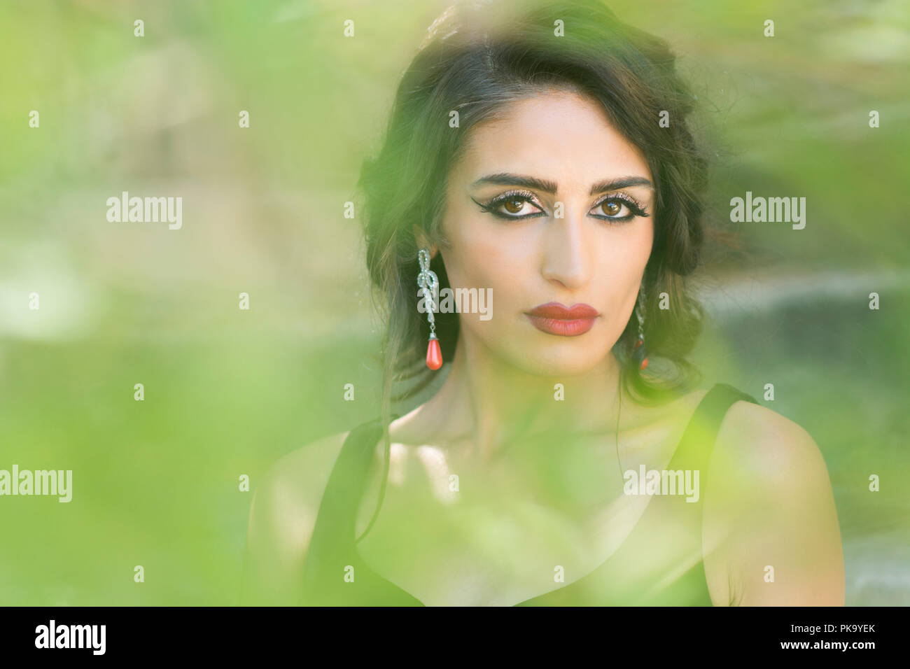 Serious beautiful woman in the garden Stock Photo - Alamy