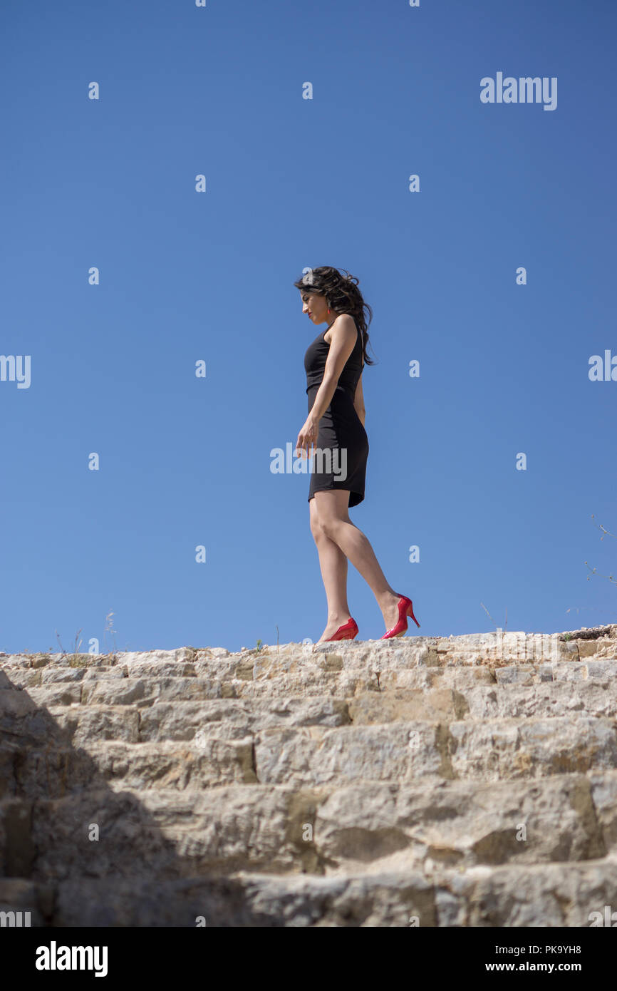 Side view of a woman walking in nature Stock Photo - Alamy