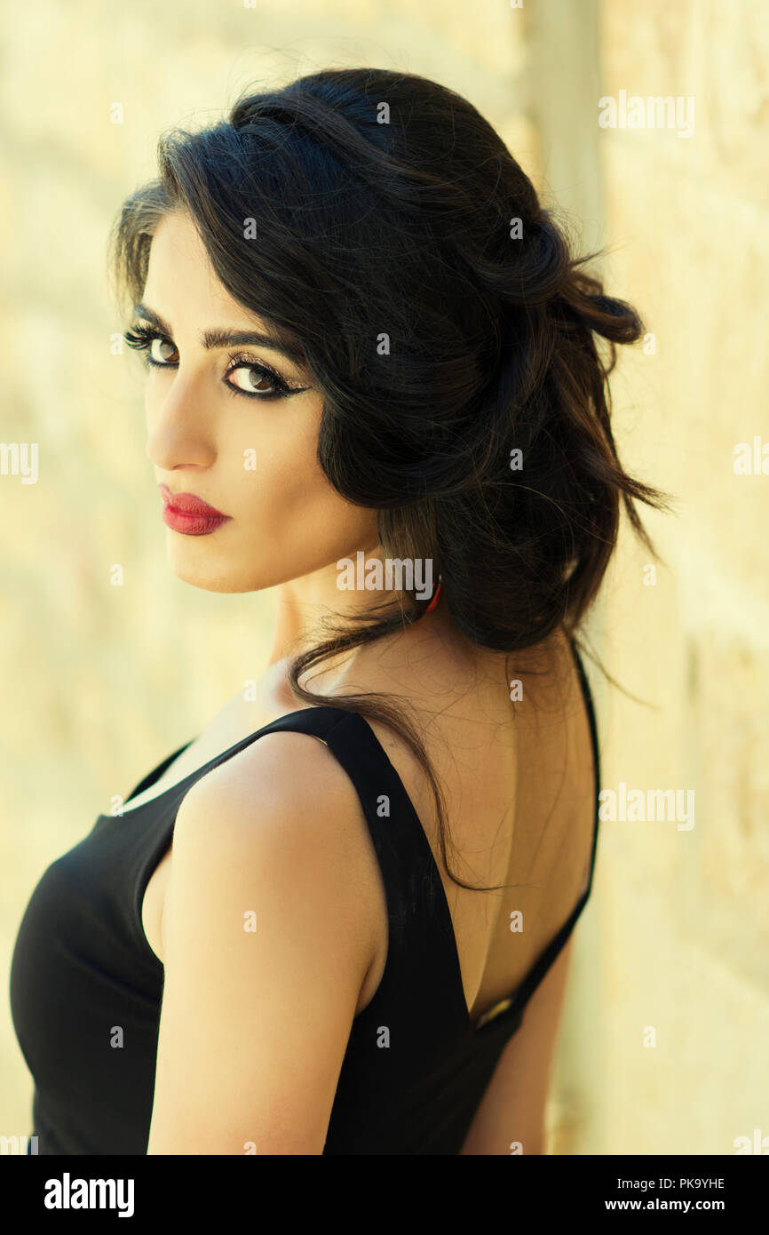 Serious woman looking over shoulder Stock Photo - Alamy