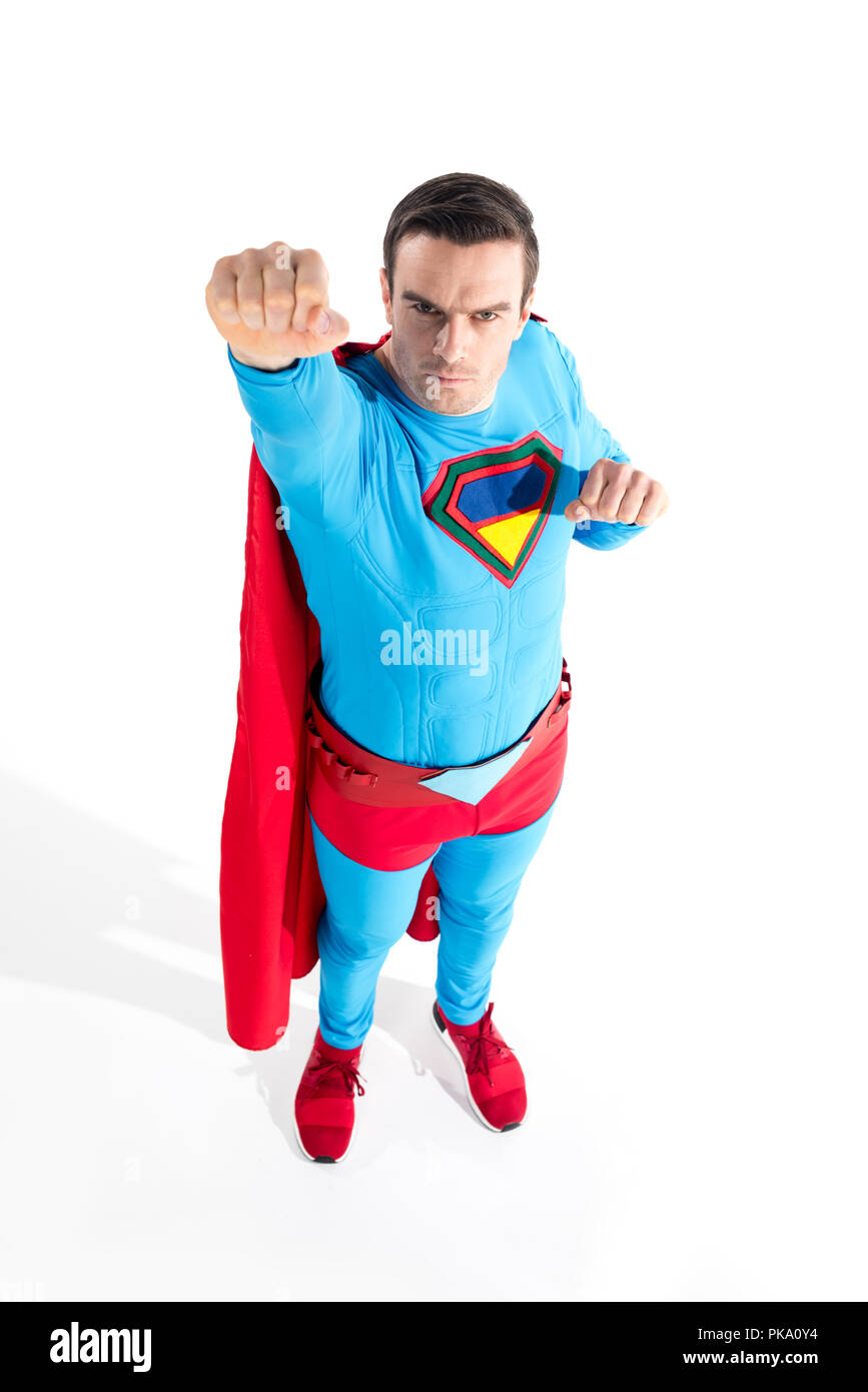 high angle view of handsome superhero raising hand and looking at ...