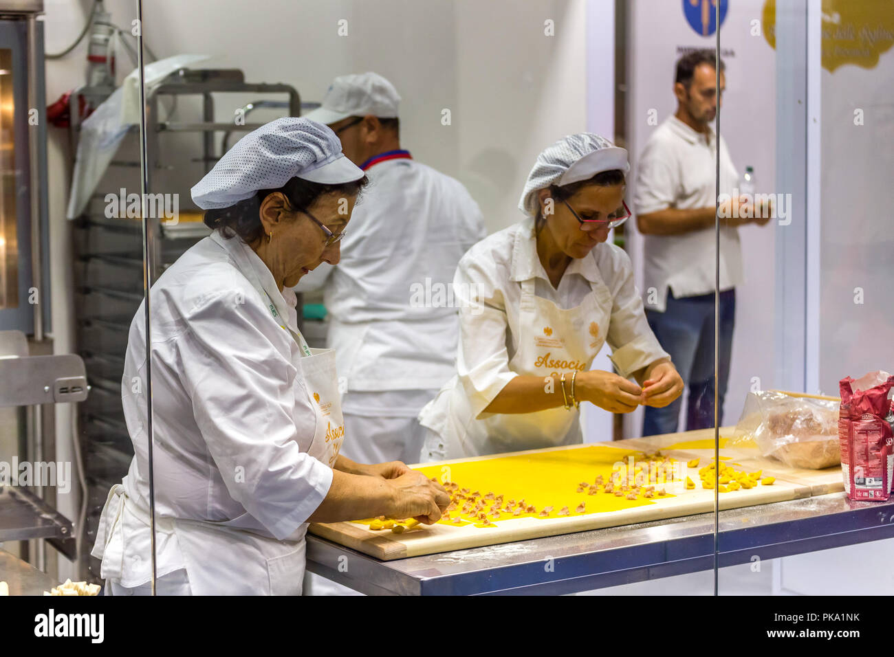 BOLOGNA (ITALY), SEPTEMBER 10, 2018: booth presenters are preparing ...