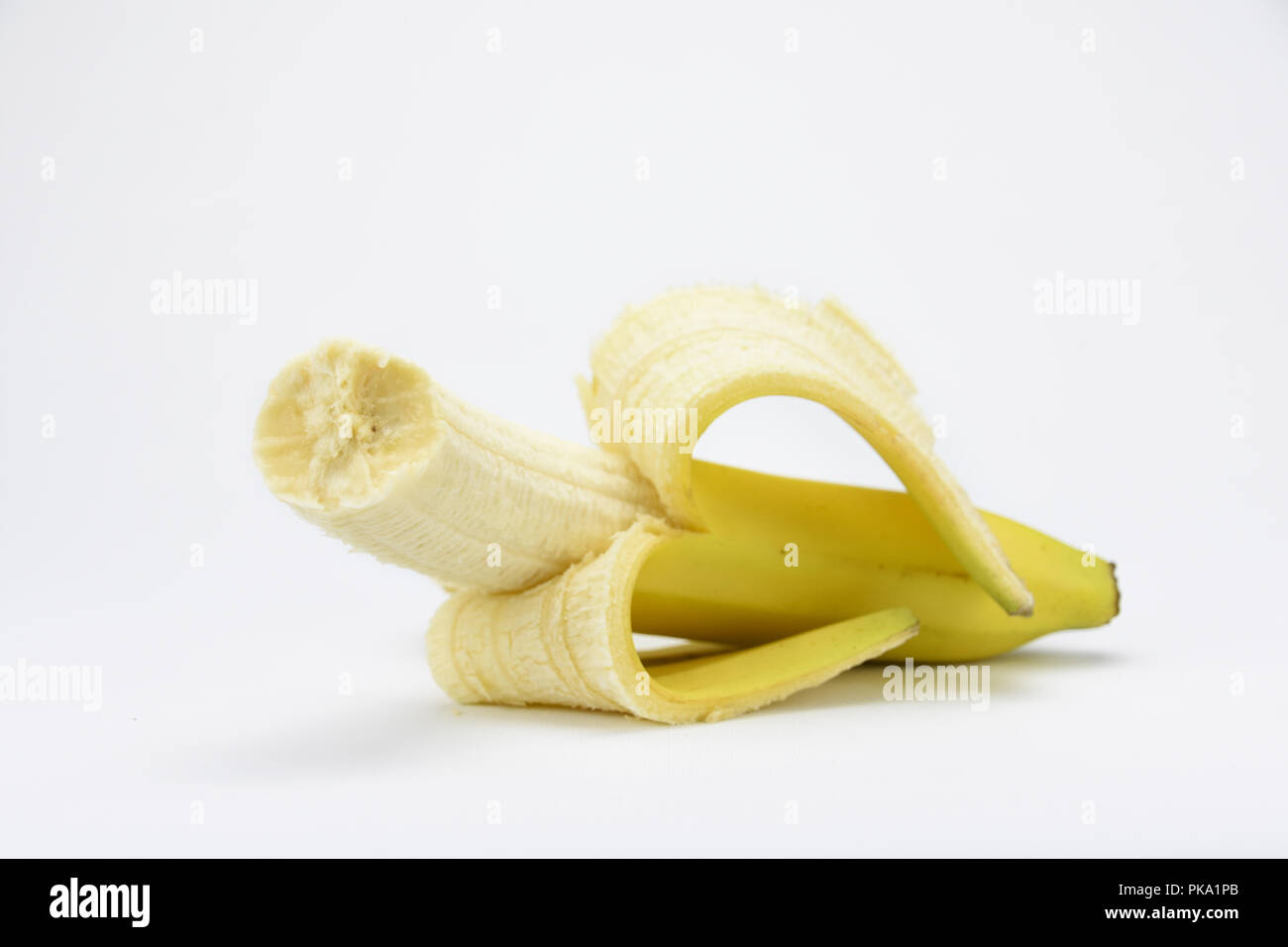 Half eaten banana open yellow banana skin isolated on white background ...