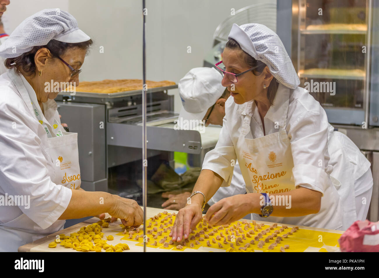 BOLOGNA (ITALY), SEPTEMBER 10, 2018: booth presenters are preparing ...