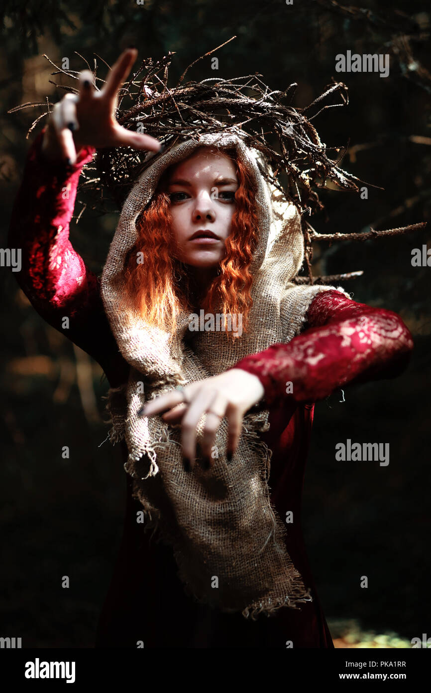 The red-haired witch holds a ritual with a crystal ball Stock Photo - Alamy