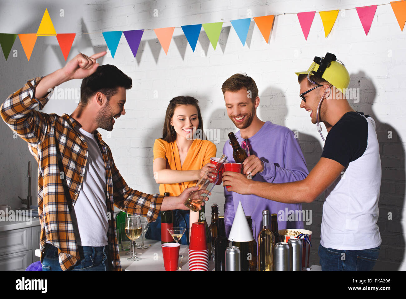 happy young friends drinking alcohol while partying together Stock ...