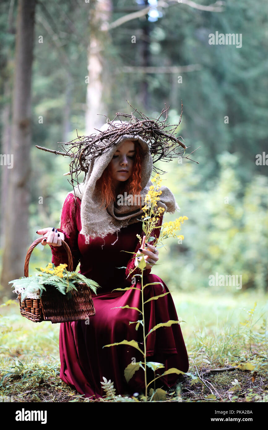 The red-haired witch holds a ritual with a crystal ball Stock Photo - Alamy