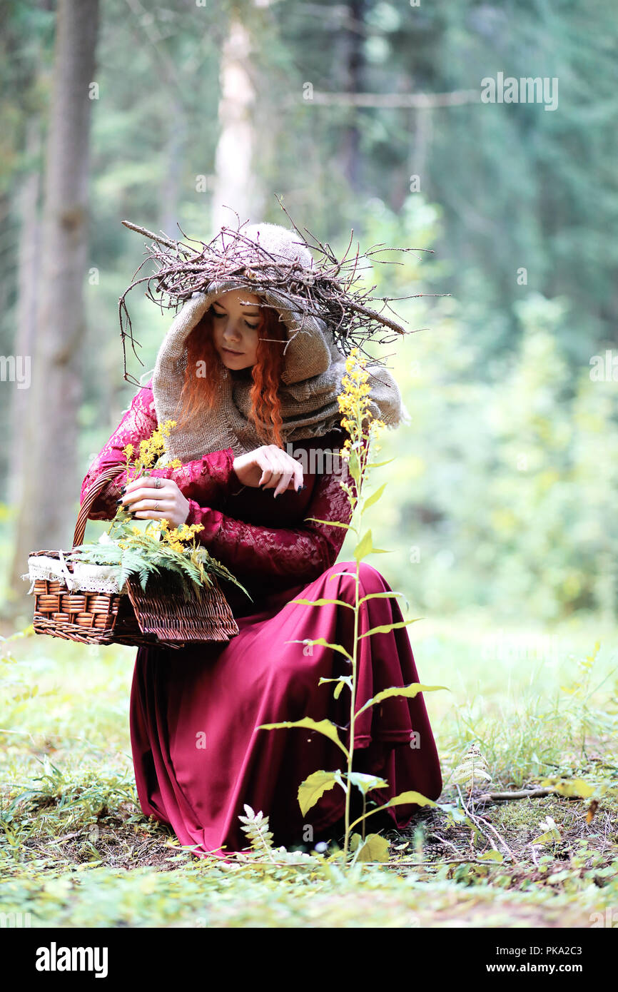 The red-haired witch holds a ritual with a crystal ball Stock Photo - Alamy