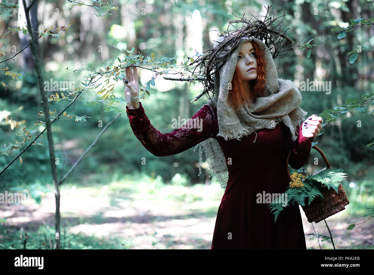 The red-haired witch holds a ritual with a crystal ball Stock Photo - Alamy