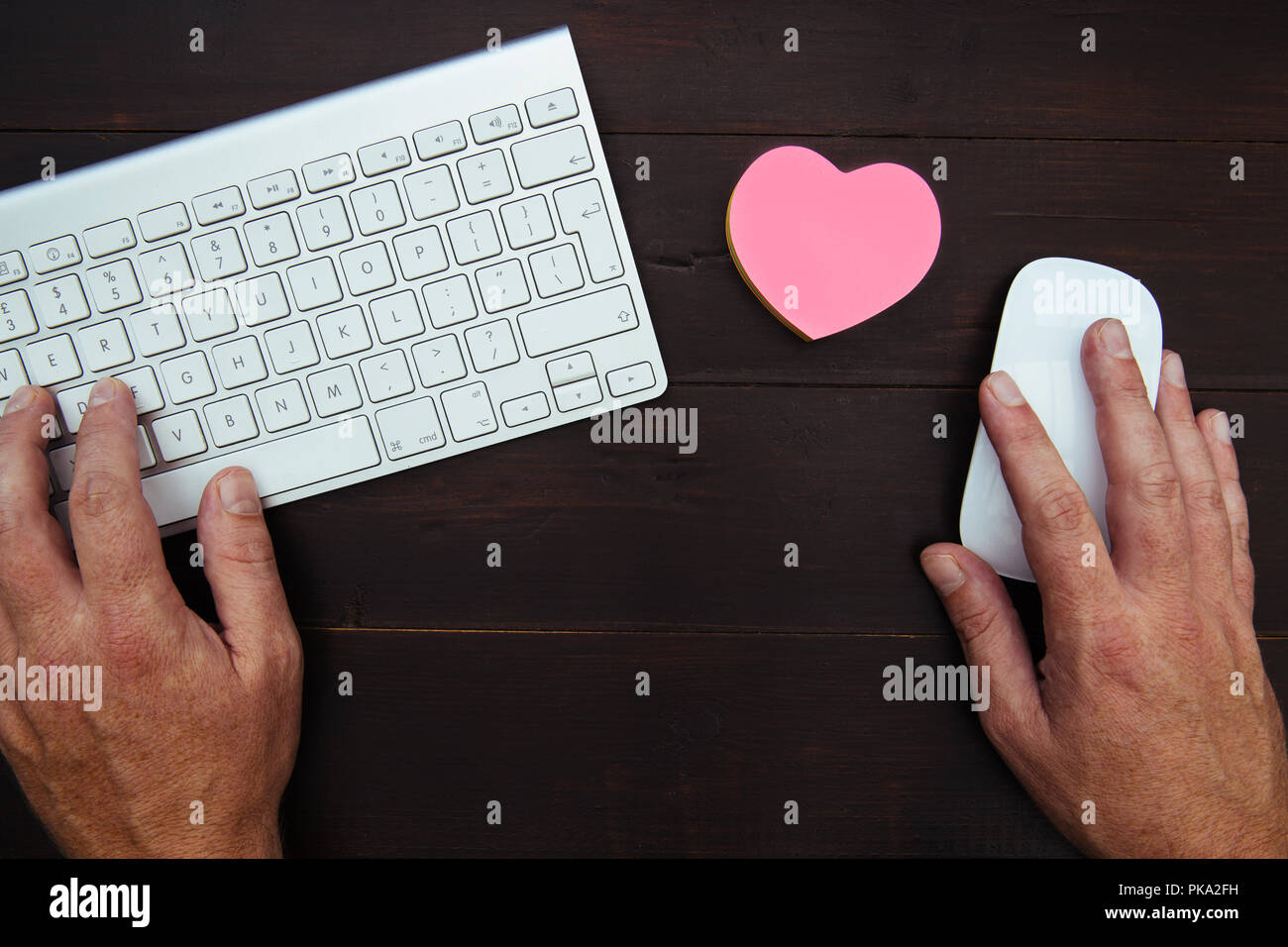 Man working at office desk with computer keyboard and mouse Stock Photo ...