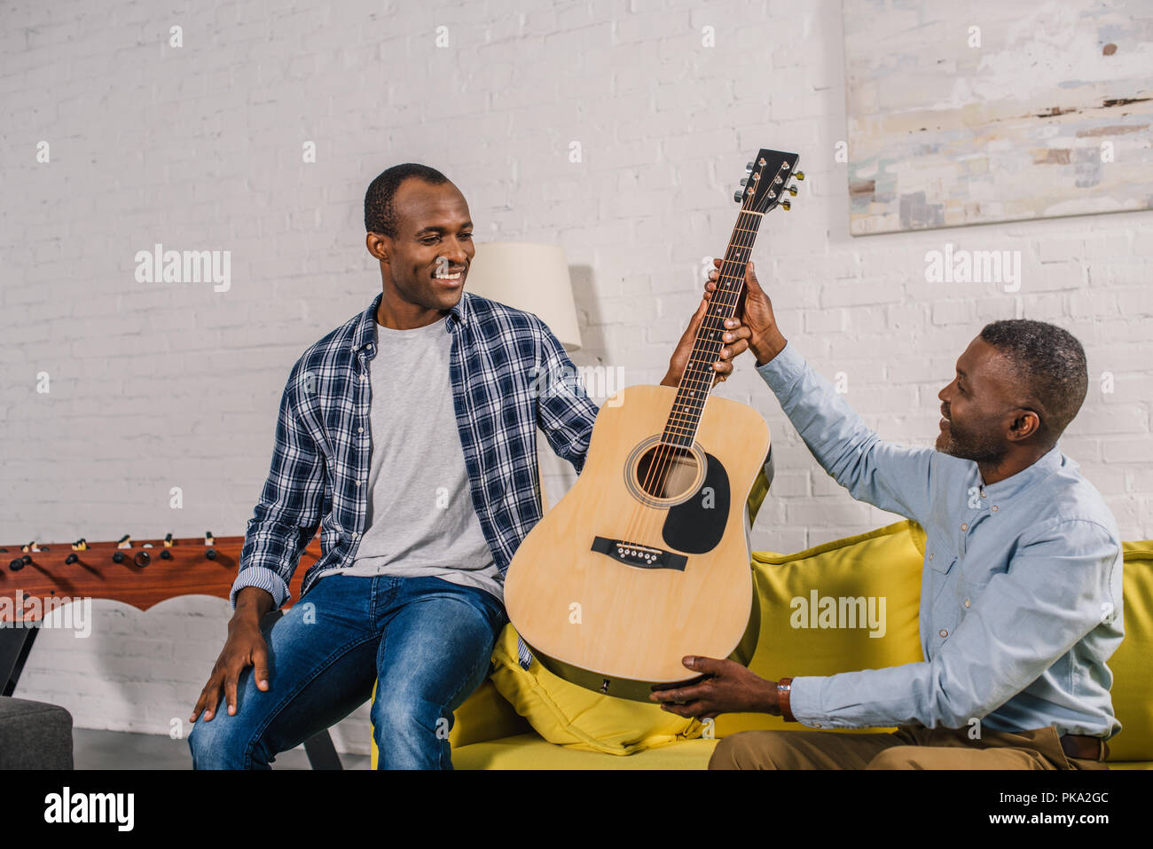 Smiling african father playing guitar hi-res stock photography and ...