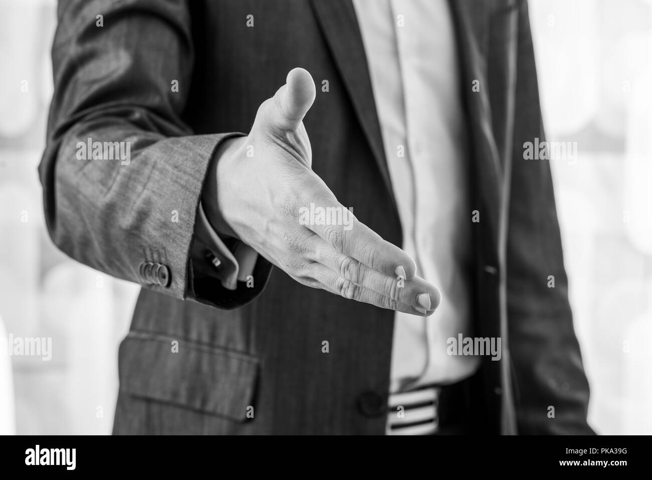 Hand reaching out suit Black and White Stock Photos & Images - Alamy